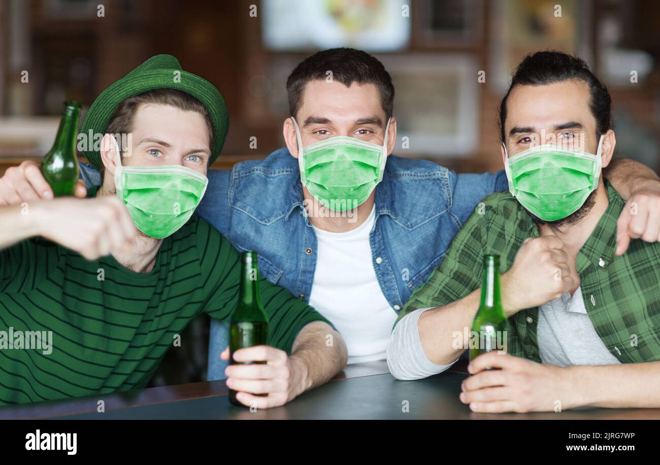 male friends in masks drinking beer at bar or pub Stock Photo - Alamy