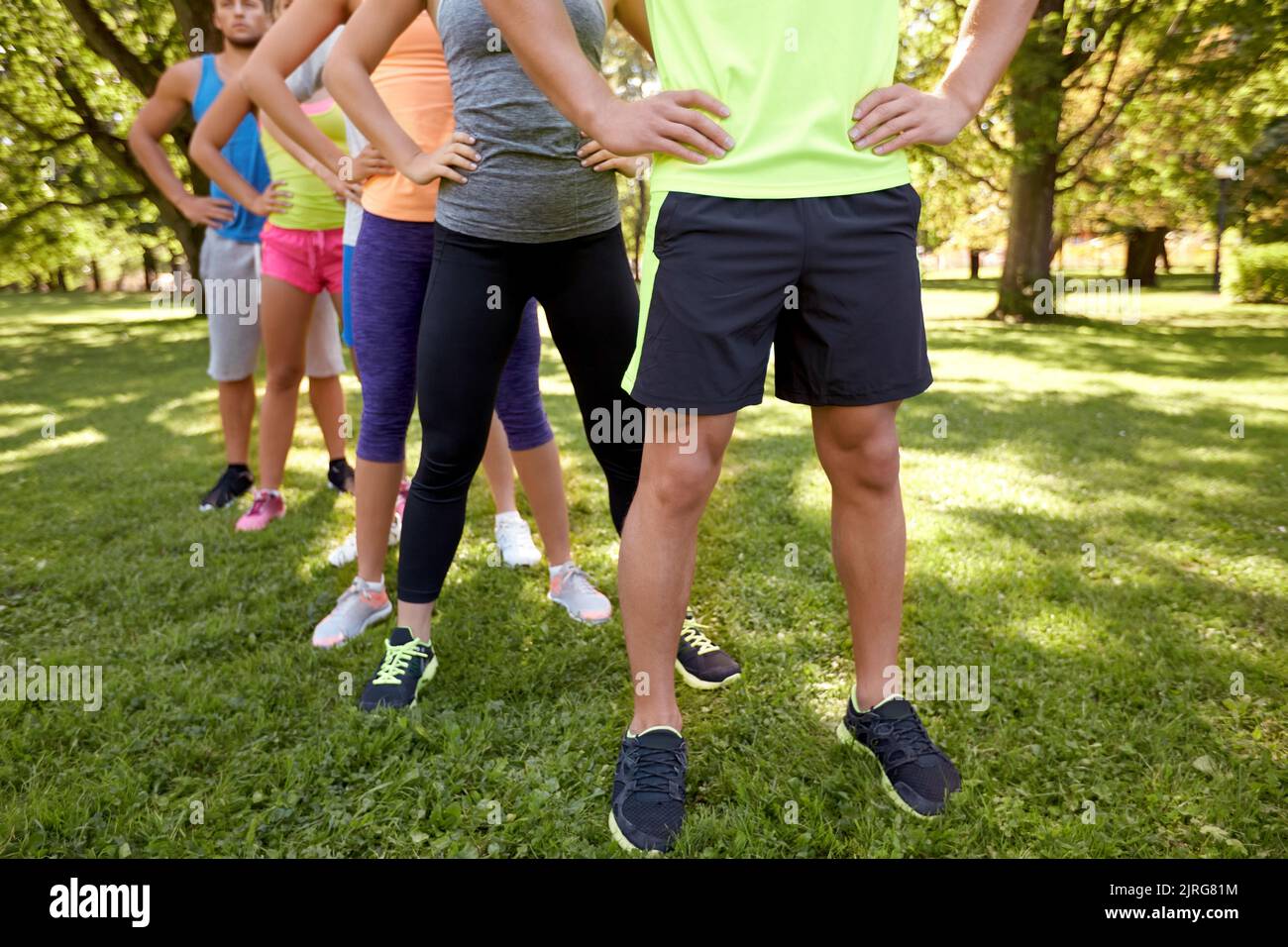 happy people exercising with trainer at park Stock Photo - Alamy