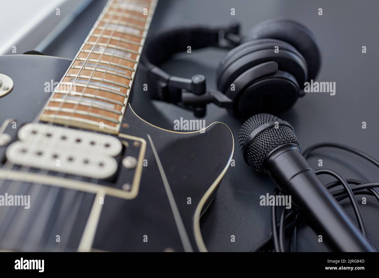close up of bass guitar, microphone and headphones Stock Photo - Alamy