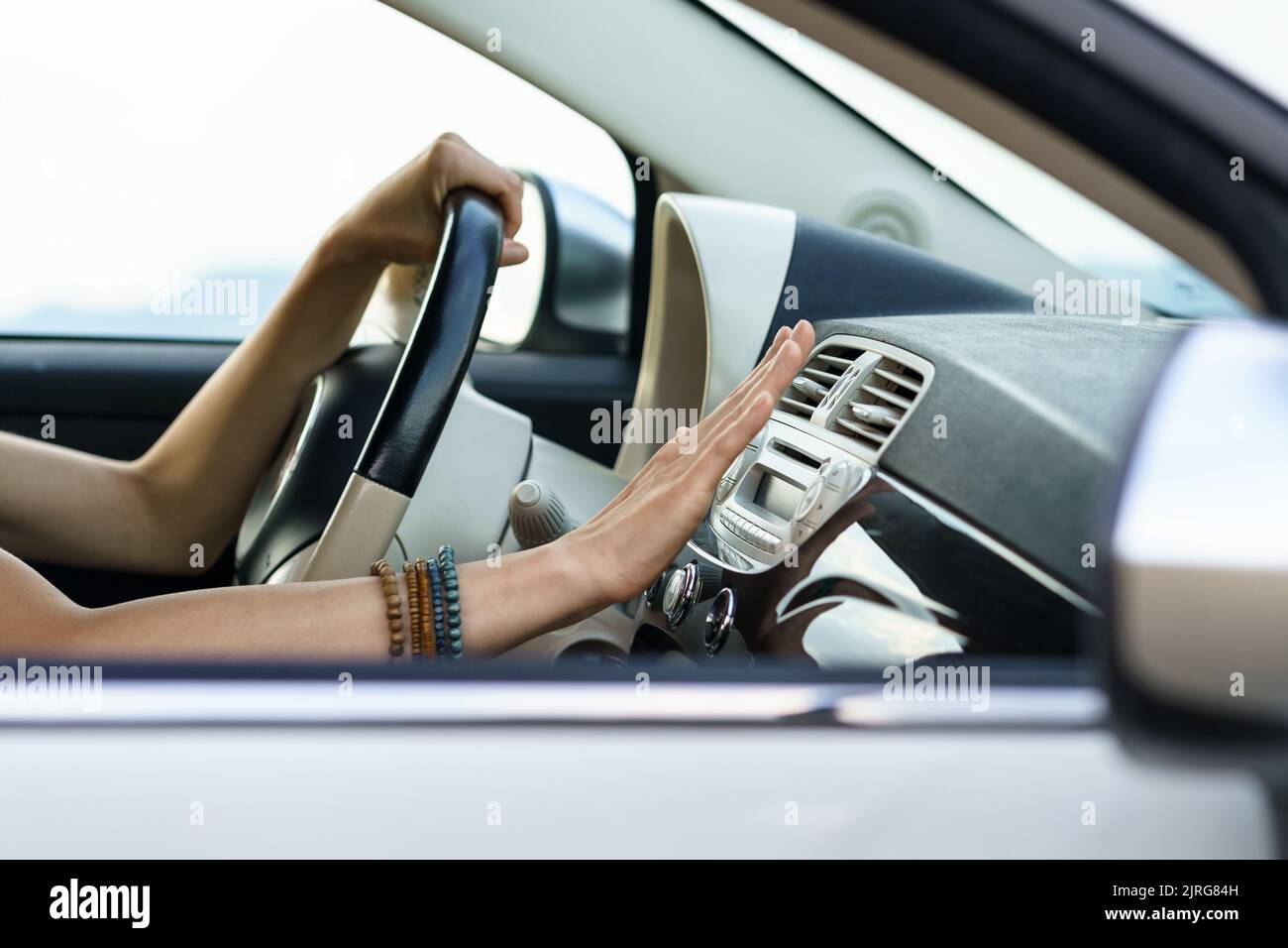 Man hand check air conditioning panel in car. Male driver holding hand ...