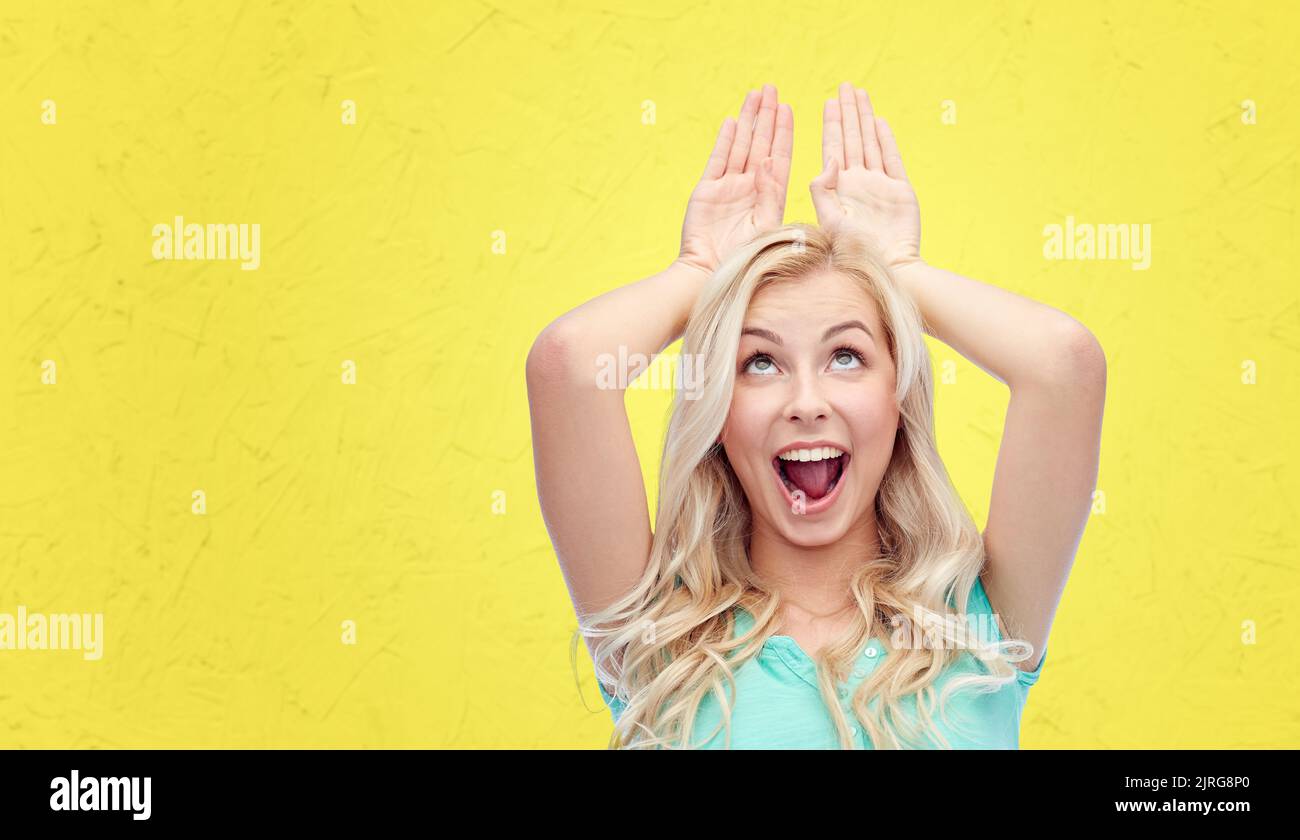 Woman making bunny ears expression hi-res stock photography and images ...