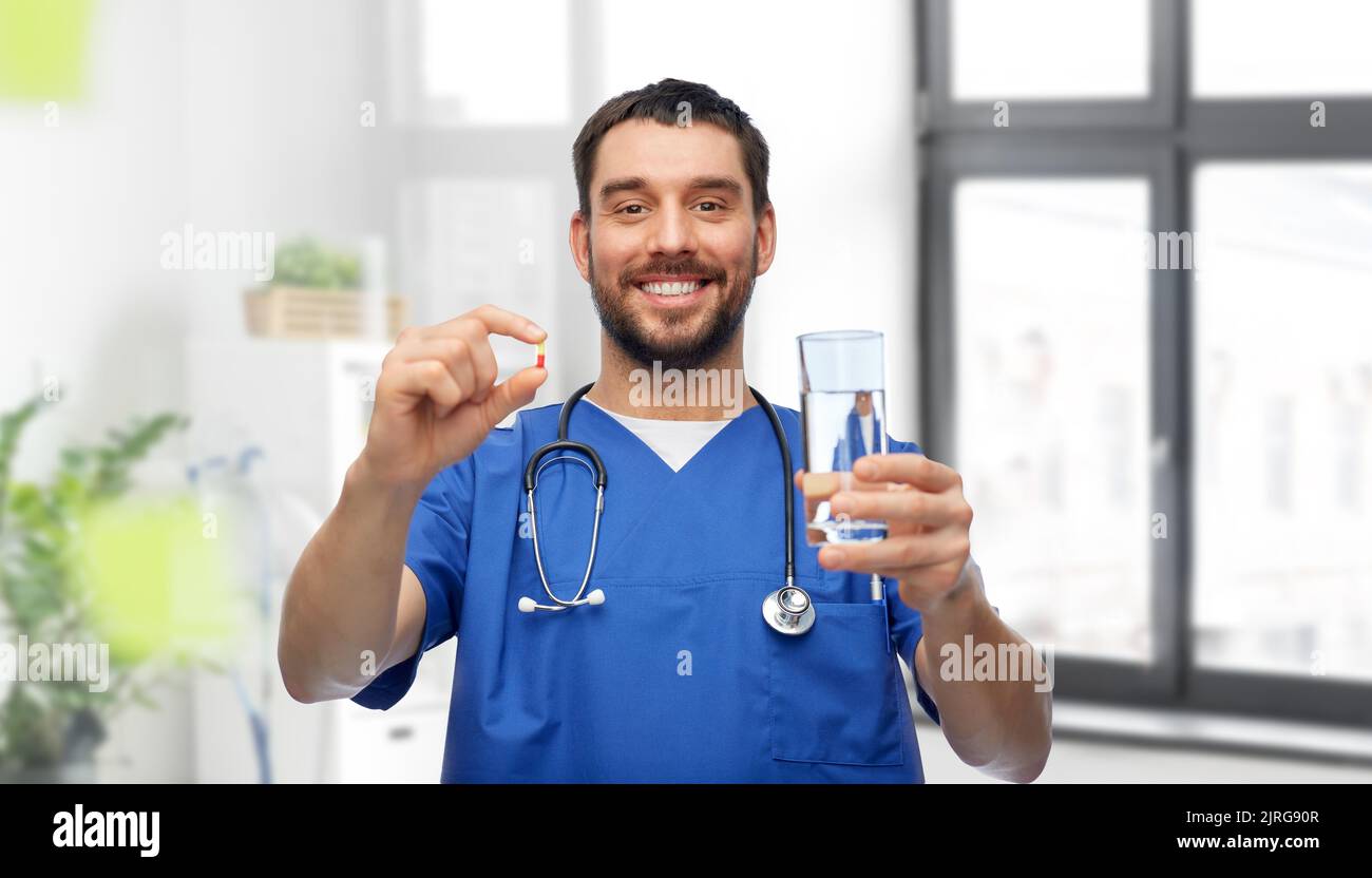 doctor or male nurse with medicine and water Stock Photo - Alamy