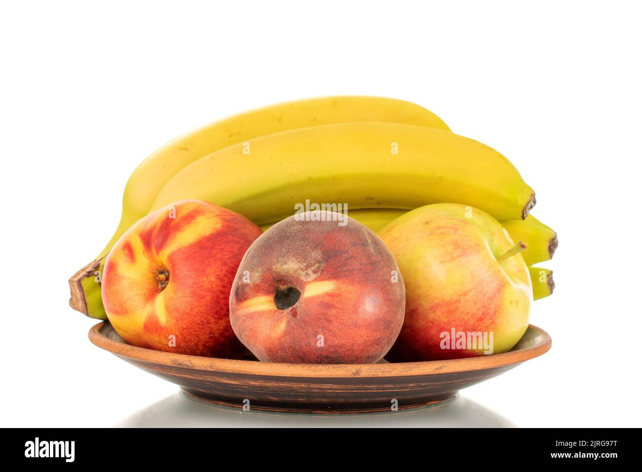 One bunch of bananas, apple, peach and nectarine on a ceramic plate ...
