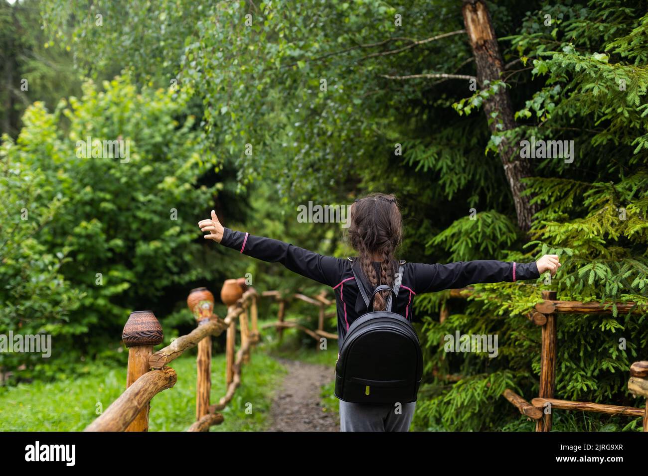 Little girl goes to the elementary school. Child with a backpack is ...