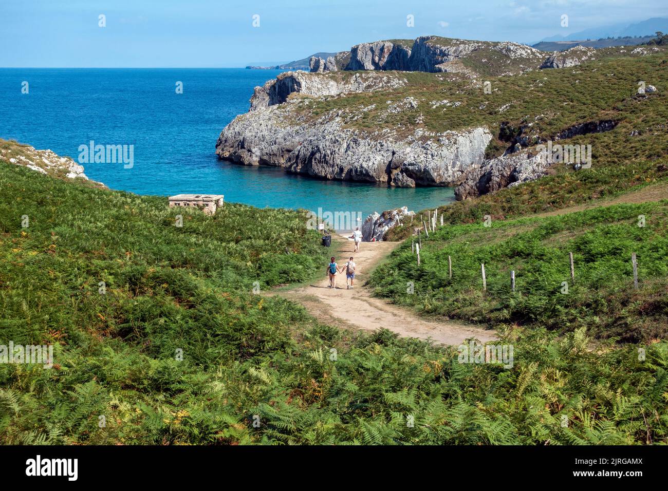 People walking to San Antonio beach, a small cove a short walk from ...