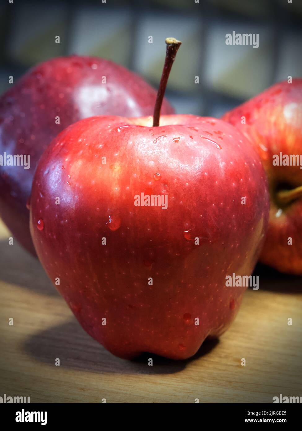 A large red apple of the Red Chief variety, a close-up shot. Water ...