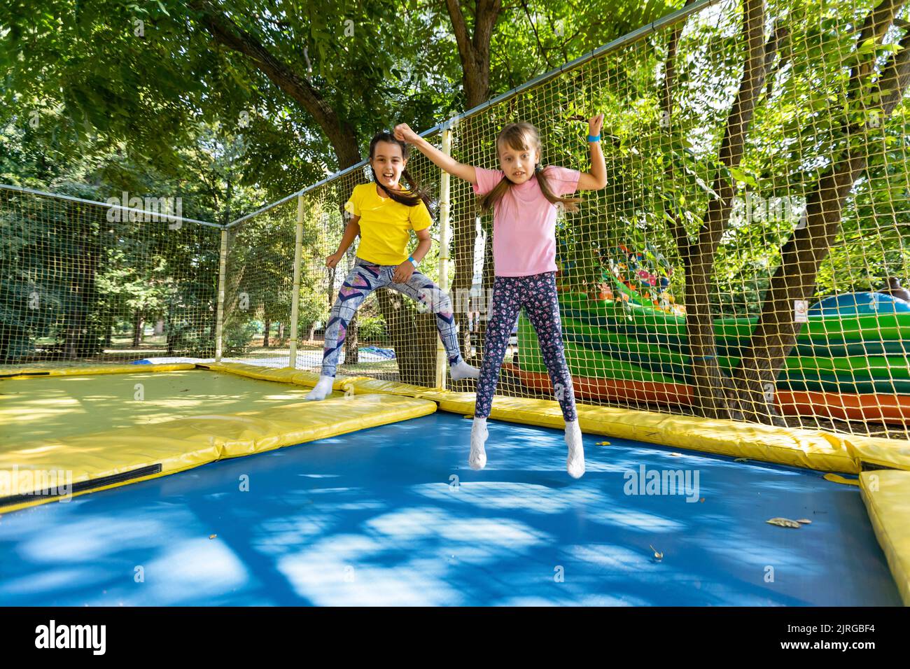 Happy children jumping on trampoline Stock Photo - Alamy