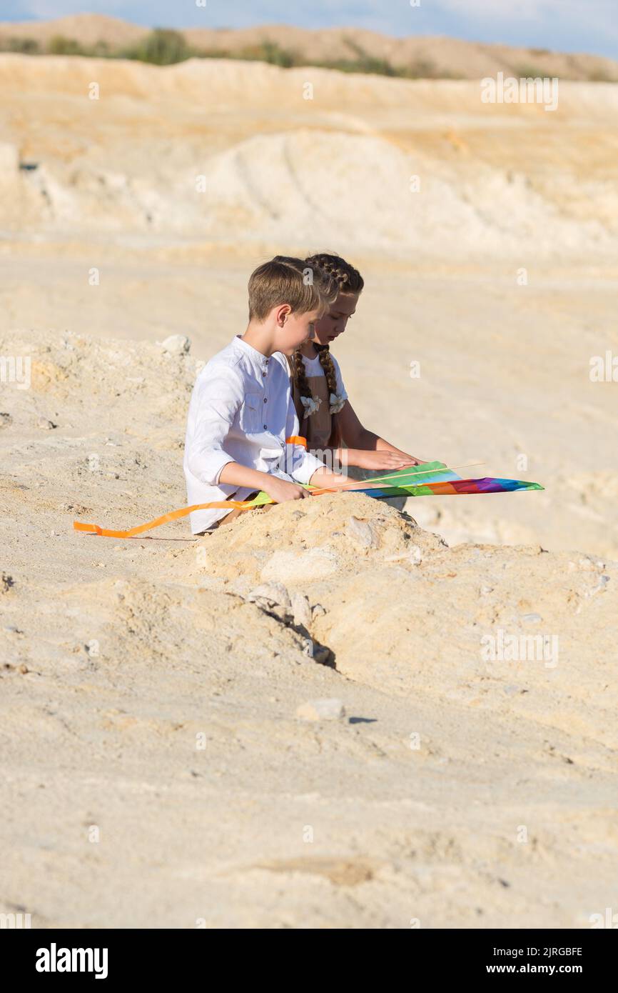 Children best friends sitting with a kite nature after school Stock ...