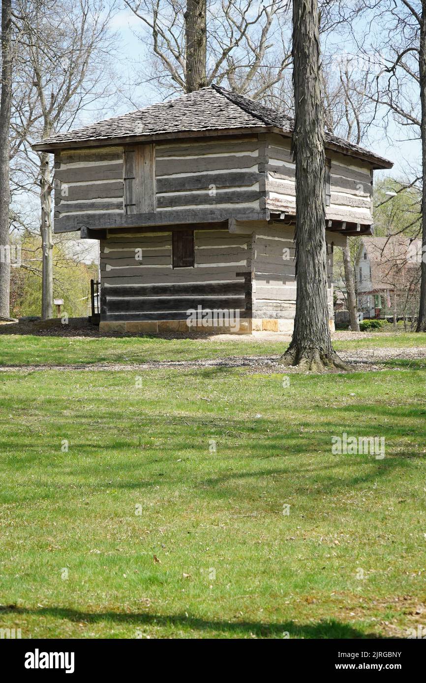 A vertical shot of an interesting wooden hut surrounded with trees in ...