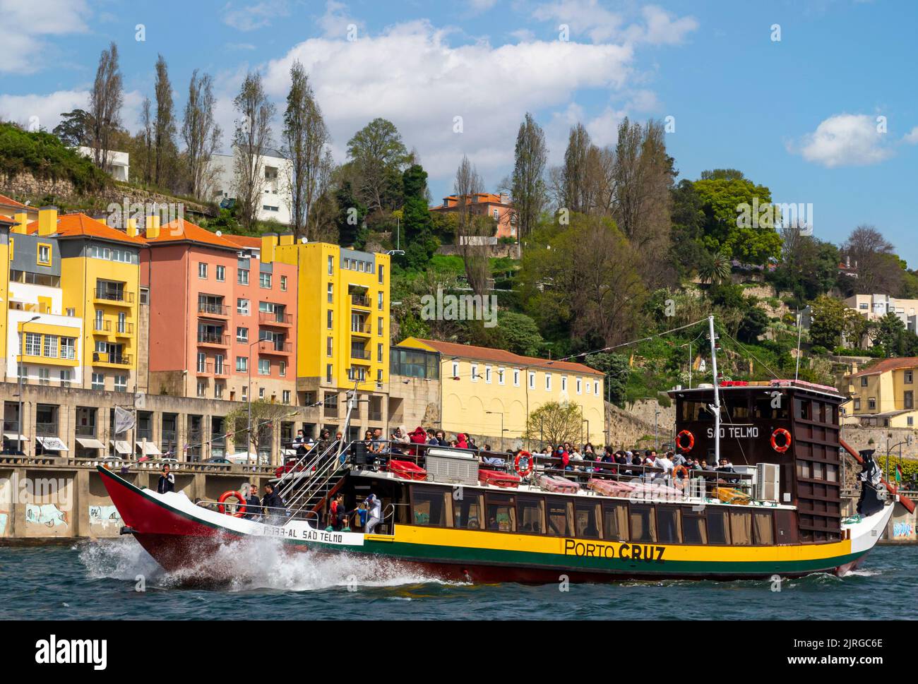 Tourist sightseeing boat sailing on the River Douro in the centre of ...
