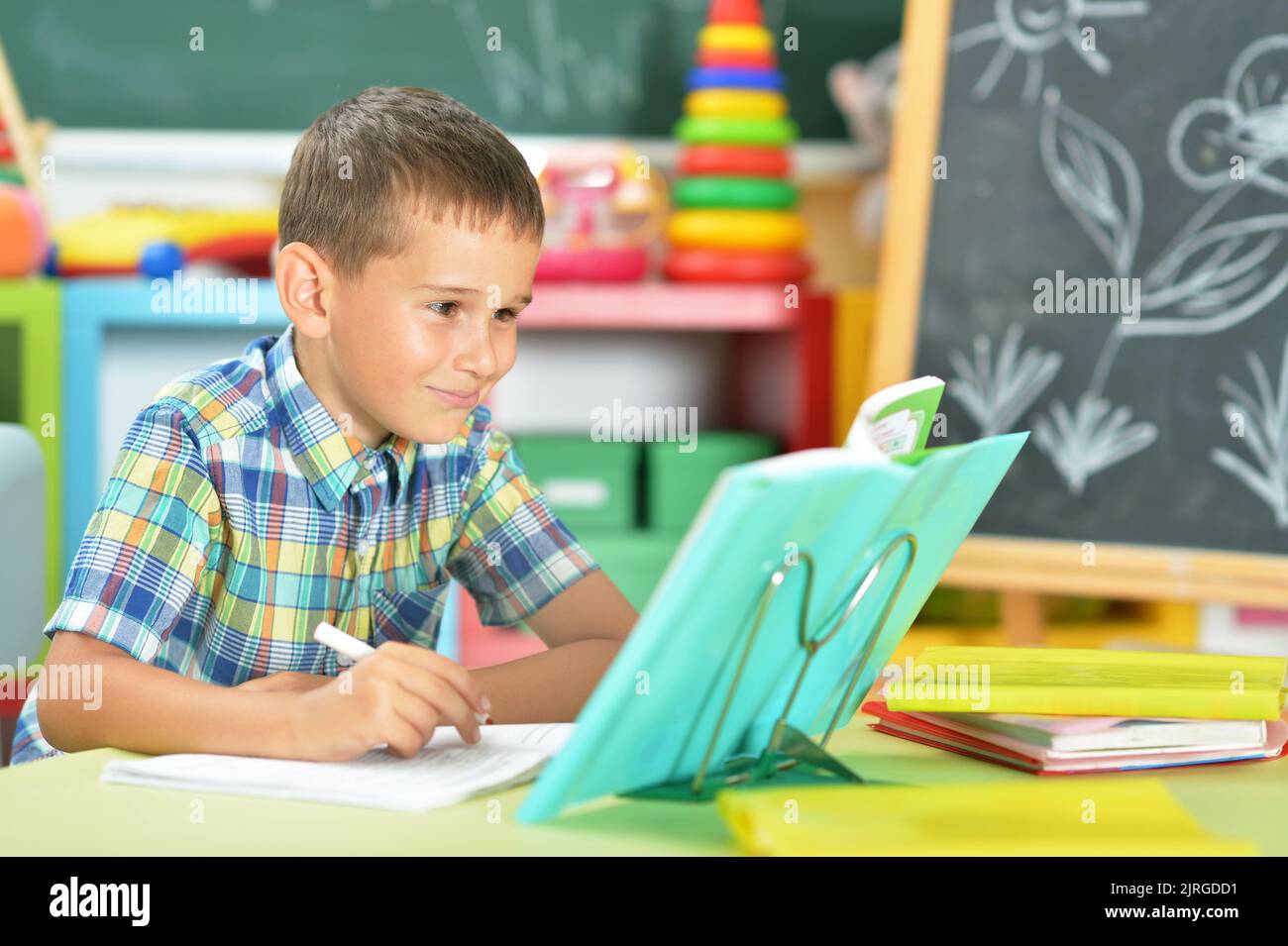 Young boy doing homework Stock Photo - Alamy