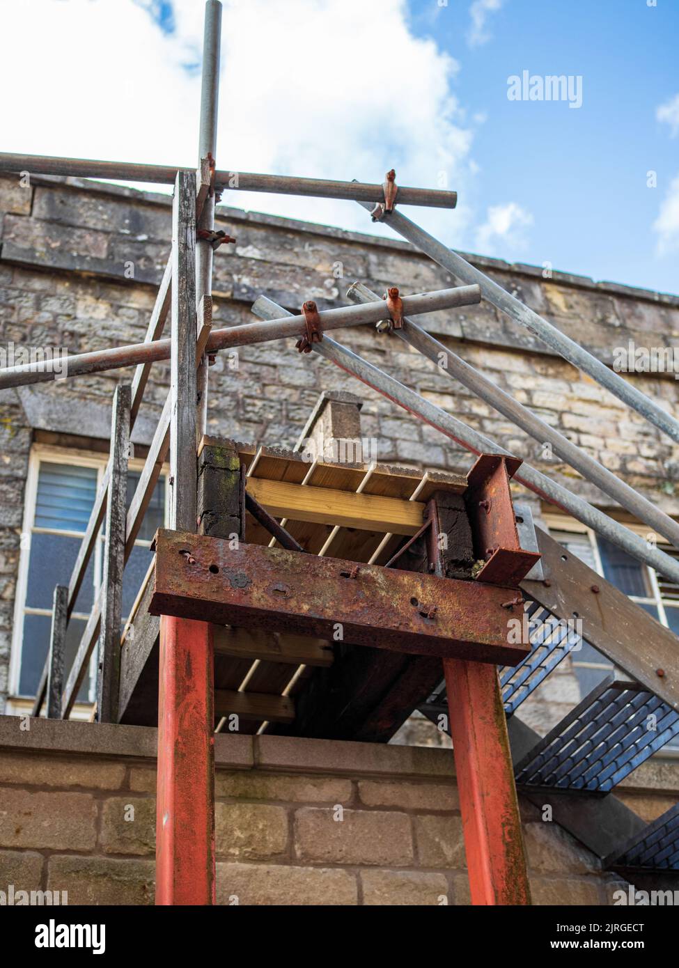 Scaffolding stair case on the outside of stone building Stock Photo - Alamy