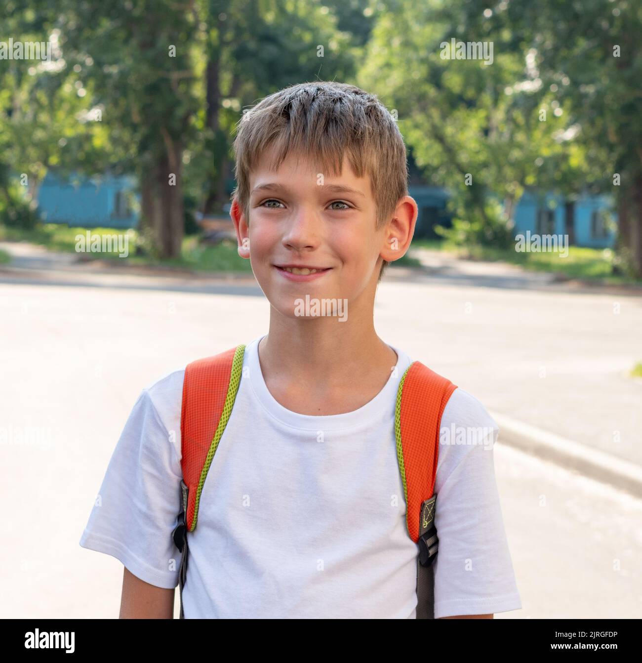 A happy smiling child goes to school. Happy boy with a backpack and a ...