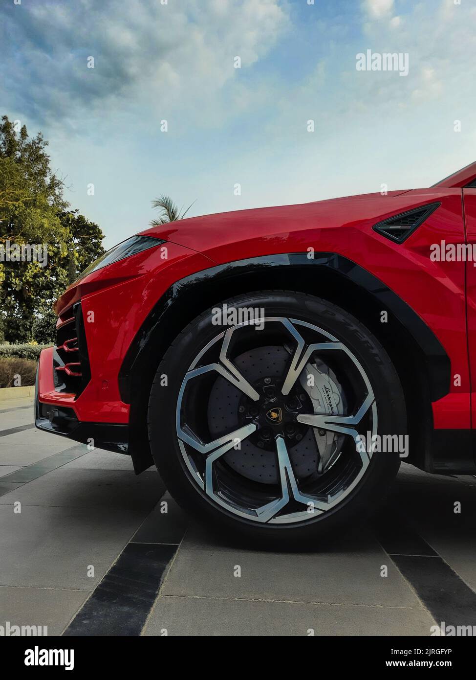 A vertical closeup of the front side of a red Lamborghini Urus Stock ...