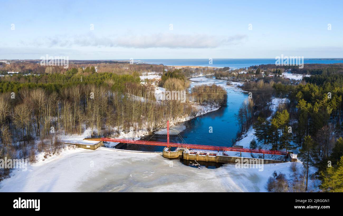 An aerial view of hydroelectric power plant in the river surrounded by ...