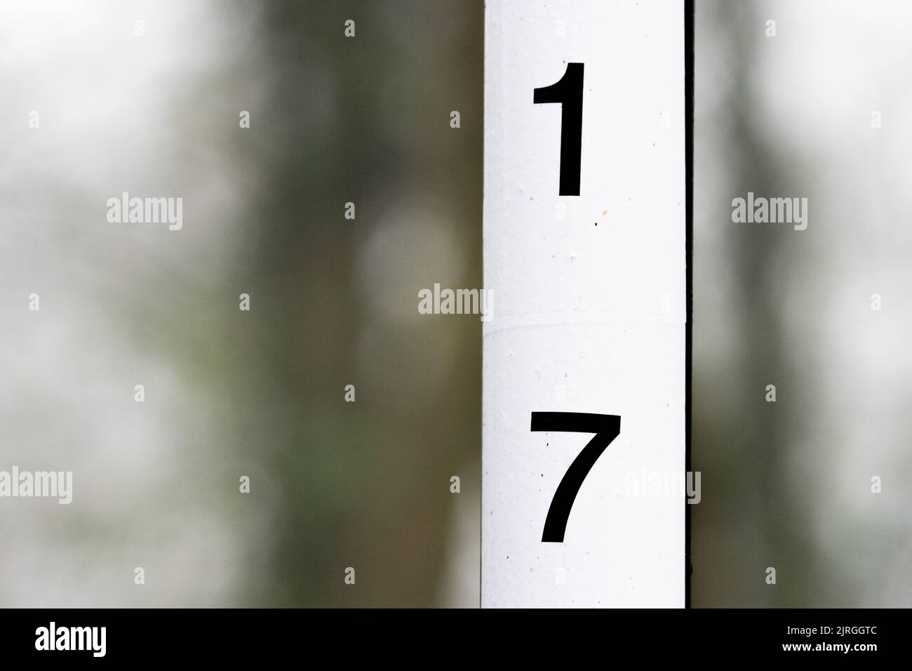 Number 17 on a post written vertically Stock Photo - Alamy