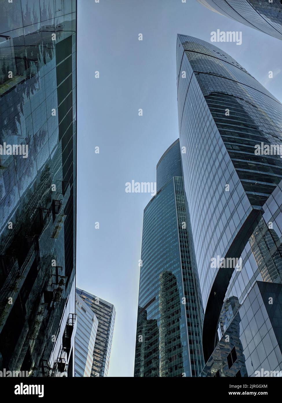 Bottom view on skyscrapers and blue sky. Modern office buildings in the ...