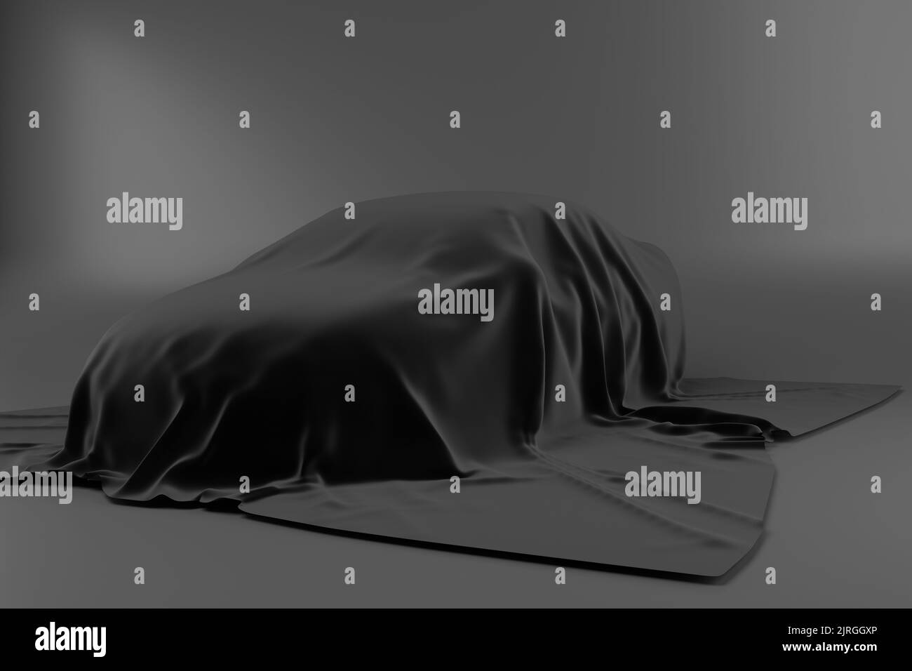 car hidden under black silk cloth cover in low light. presentation or ...