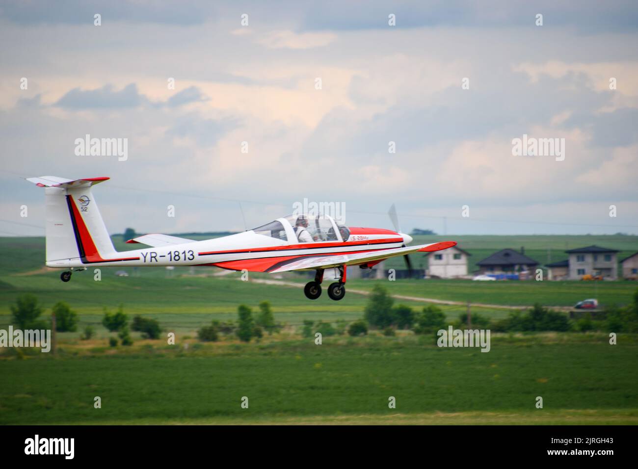 An airplane flying over a greenery landscape in the show at Hangariada ...