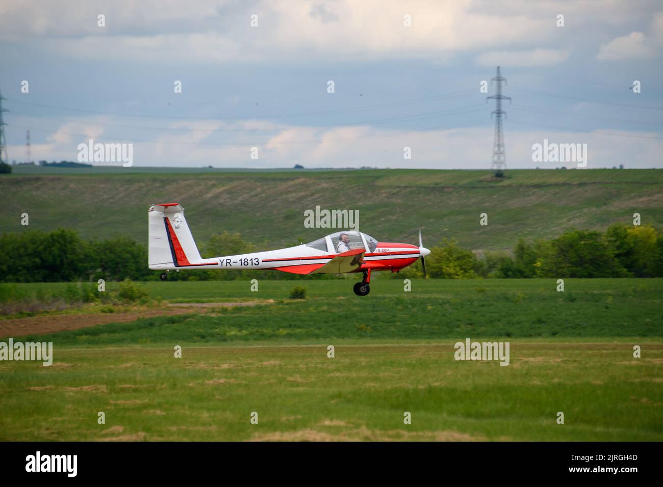 An airplane taking off over a greenery landscape at Hangariada ...
