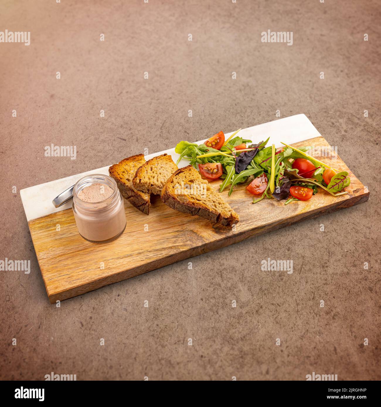 Homemade turkey liver pate in a glass jar served with toasted bread and ...