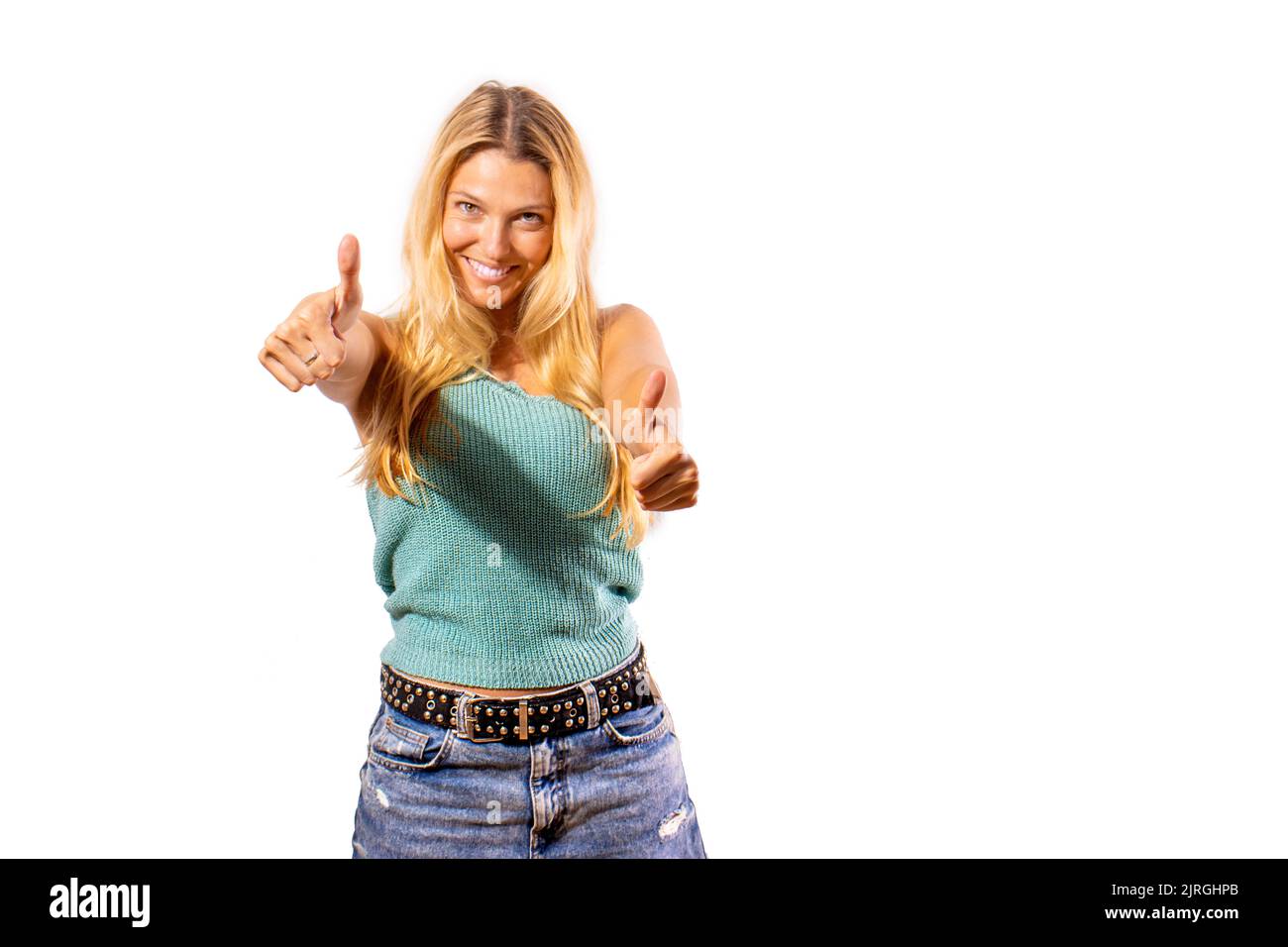 Motivated and smiling rocker girl gives a thumbs up as a sign of ...