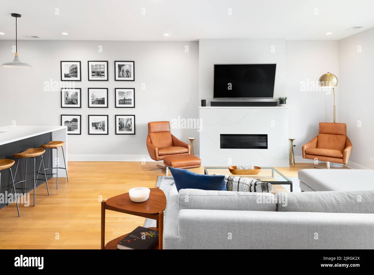 A beautiful living area with a television mounted over a fireplace ...