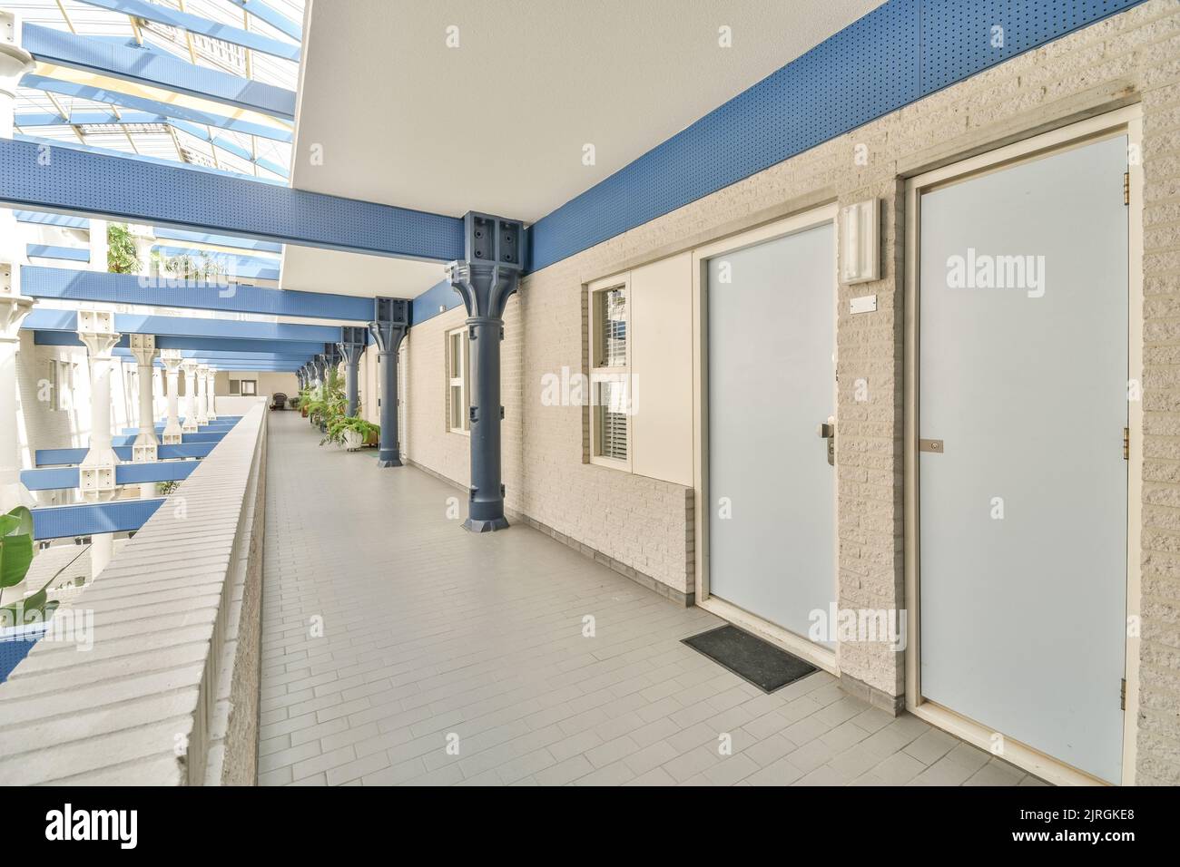 Corridor of contemporary apartment and opened doorway leading to ...