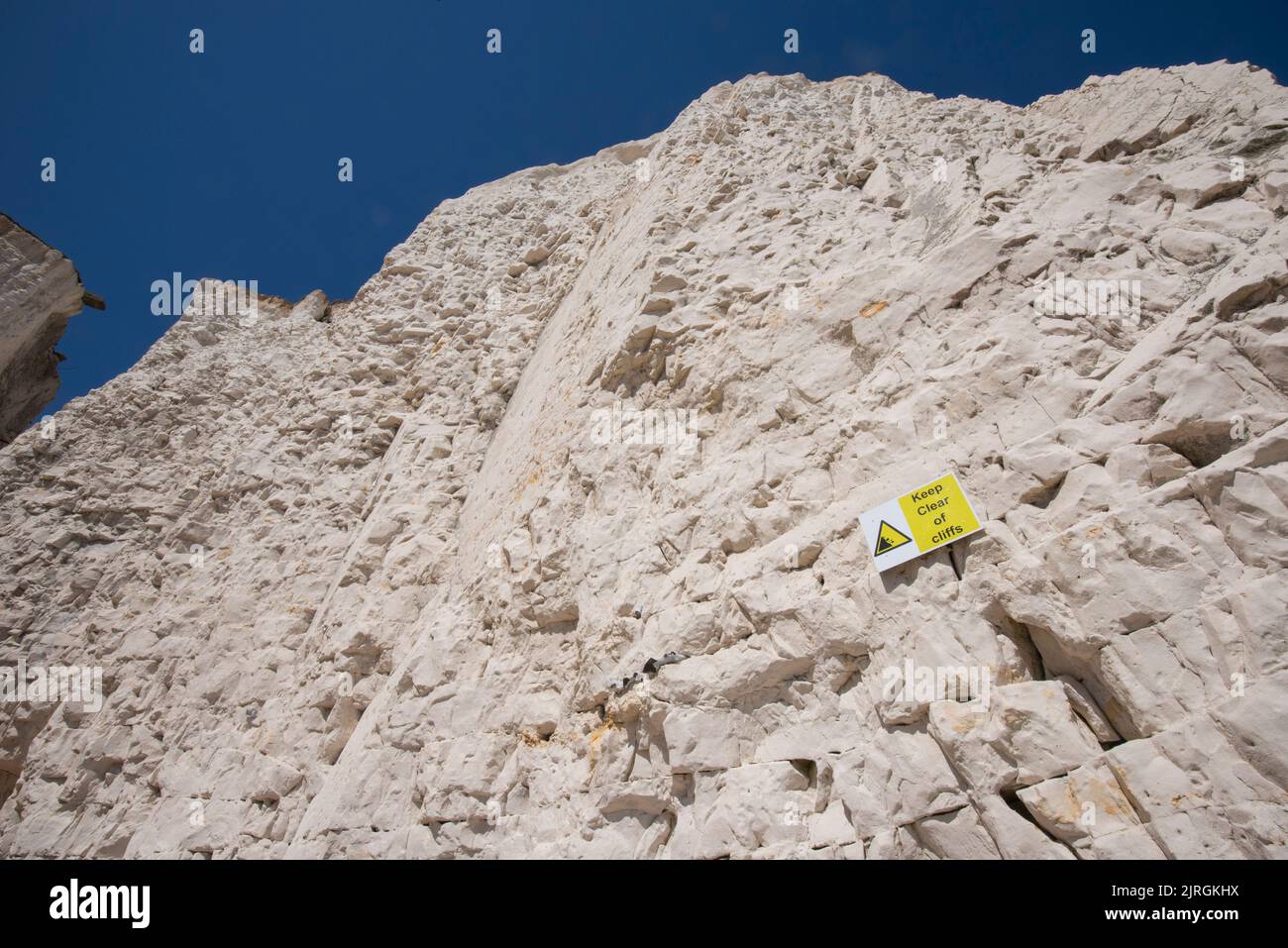 A warning sign on the chalk cliffs at Botany Bay in Kent England in the ...