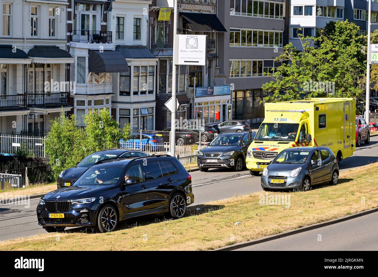 Rotterdam, Netherlands - August 2022: Cars mounting the grass verge on ...