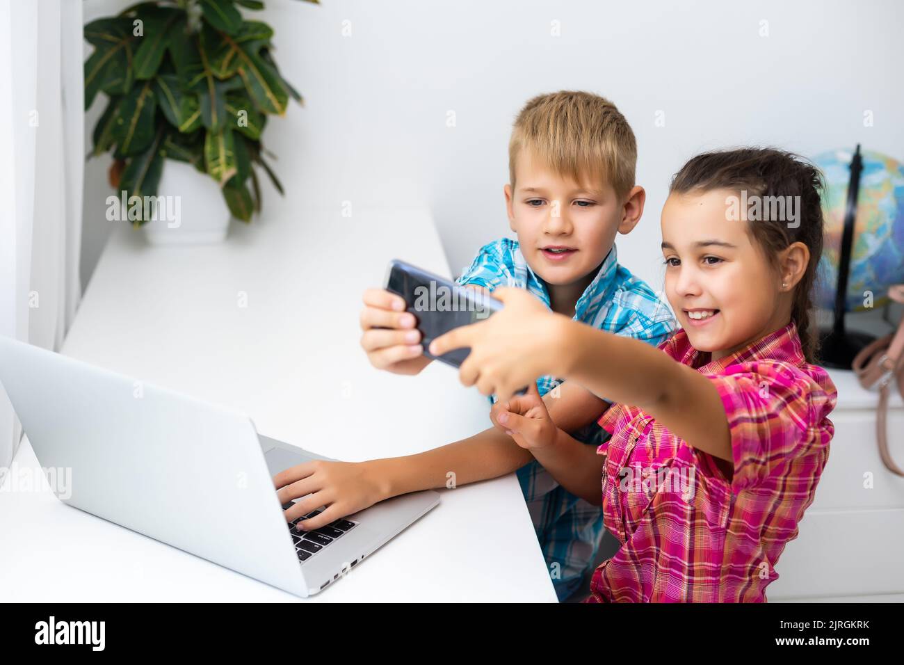 Kids playing with laptop computer at home Stock Photo - Alamy