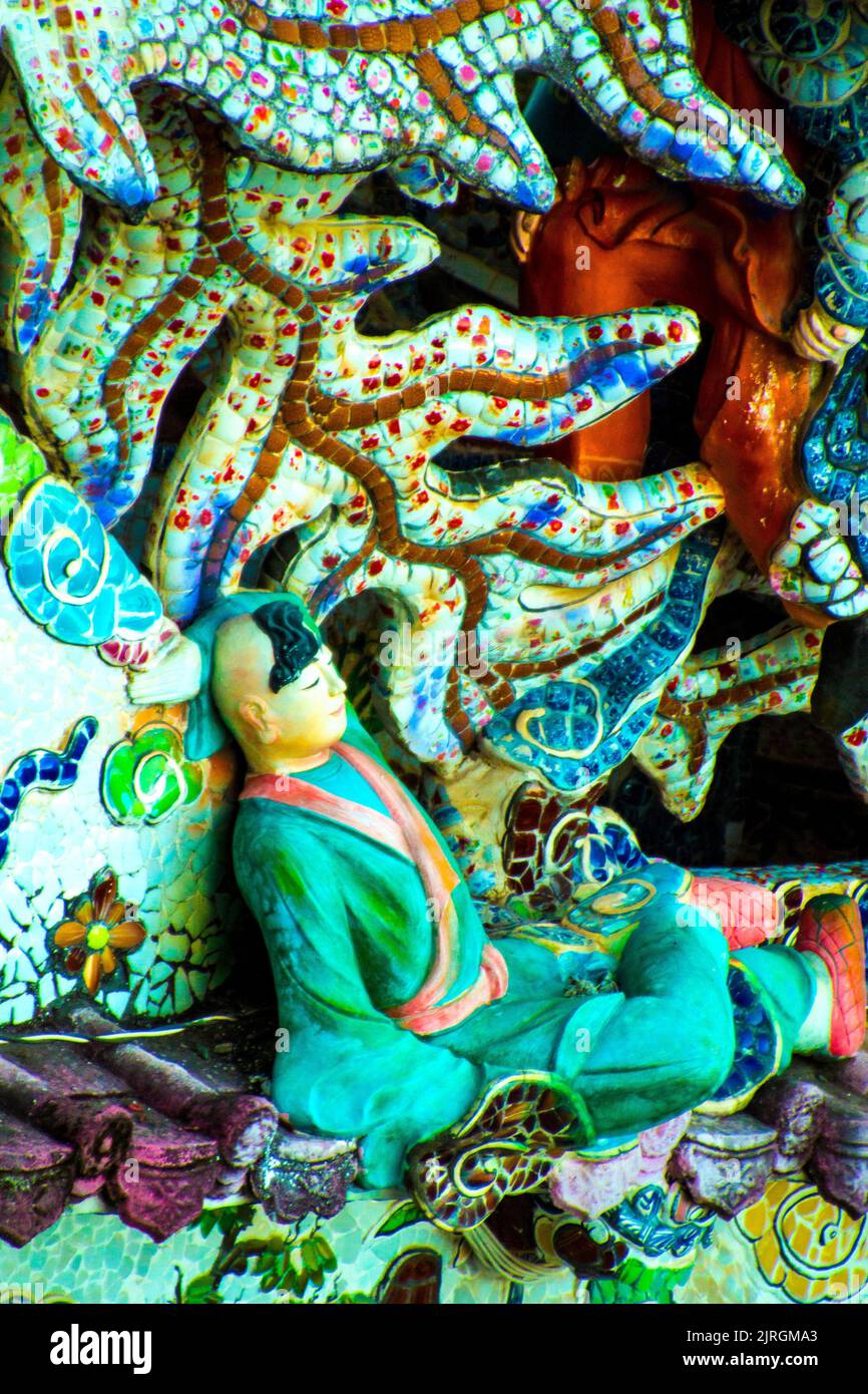 A vertical closeup of a ceramic statue from a pagoda in Saigon, Vietnam ...