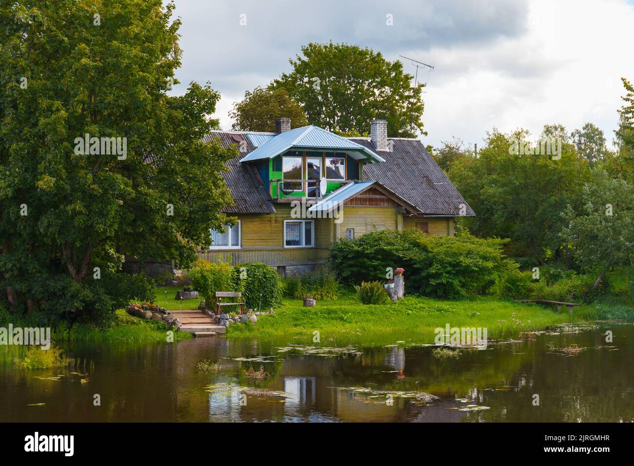 Rural house by the river Stock Photo - Alamy