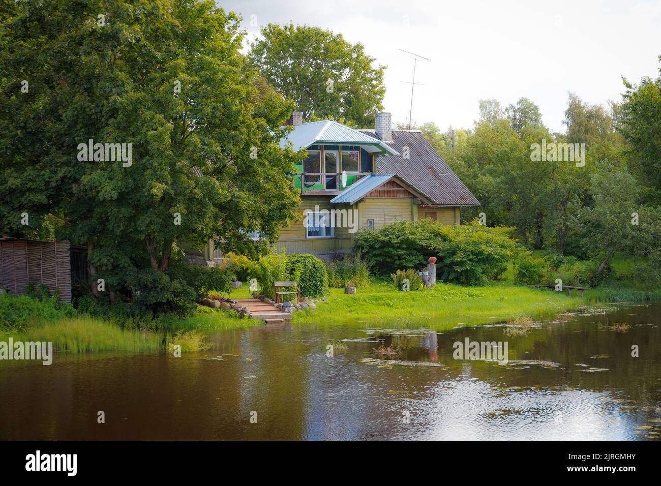 Rural house by the river Stock Photo - Alamy