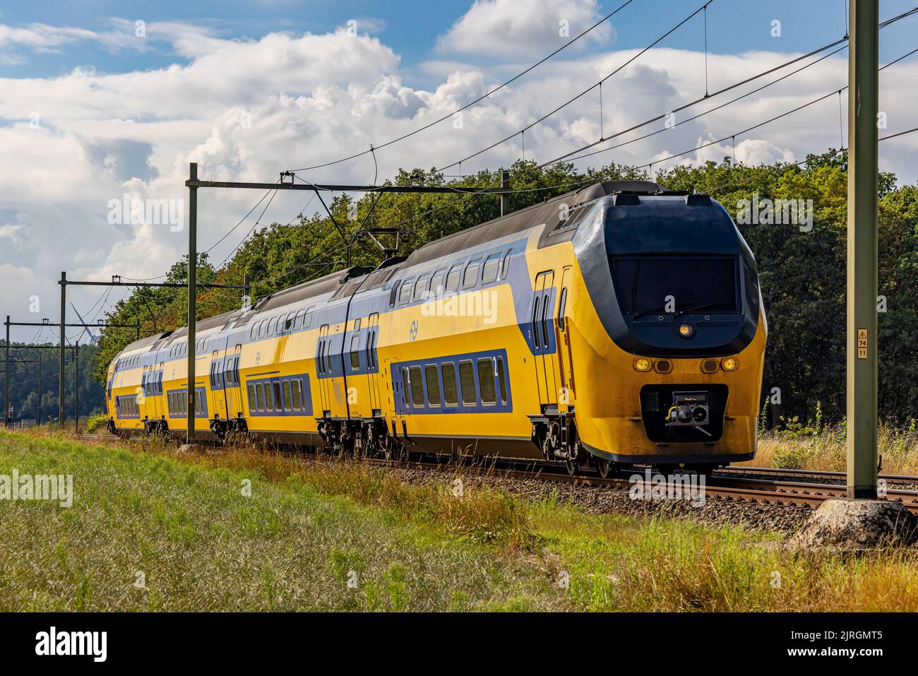 A yellow intercity train on a track in Limburg, the Netherlands Stock ...