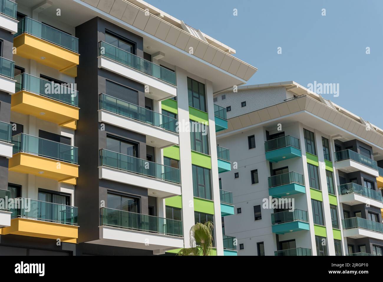 Modern freshly built apartment buildings on a sunny day with blue sky ...