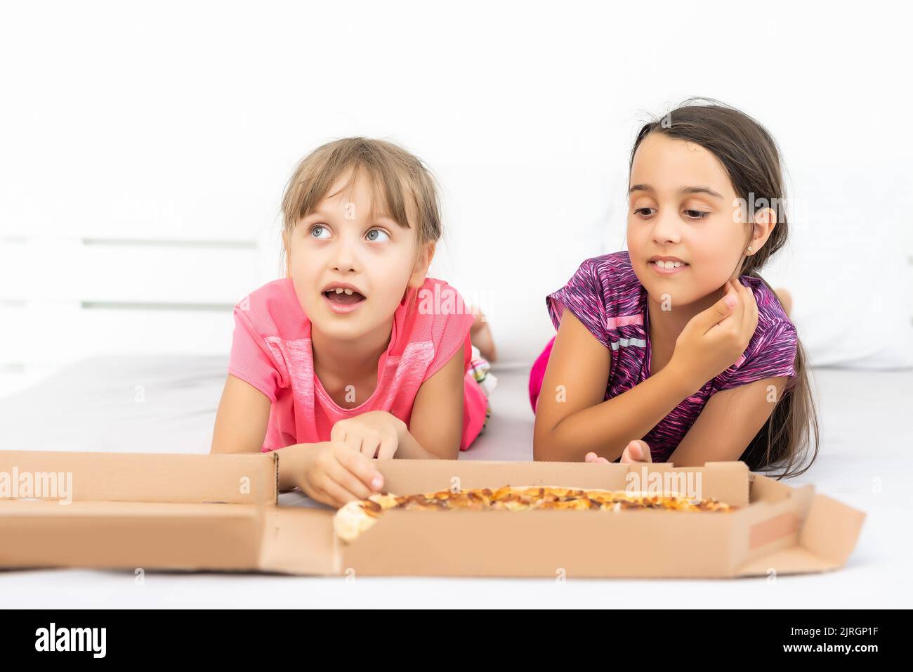 Attractive little girls posing with pizza boxes Stock Photo - Alamy