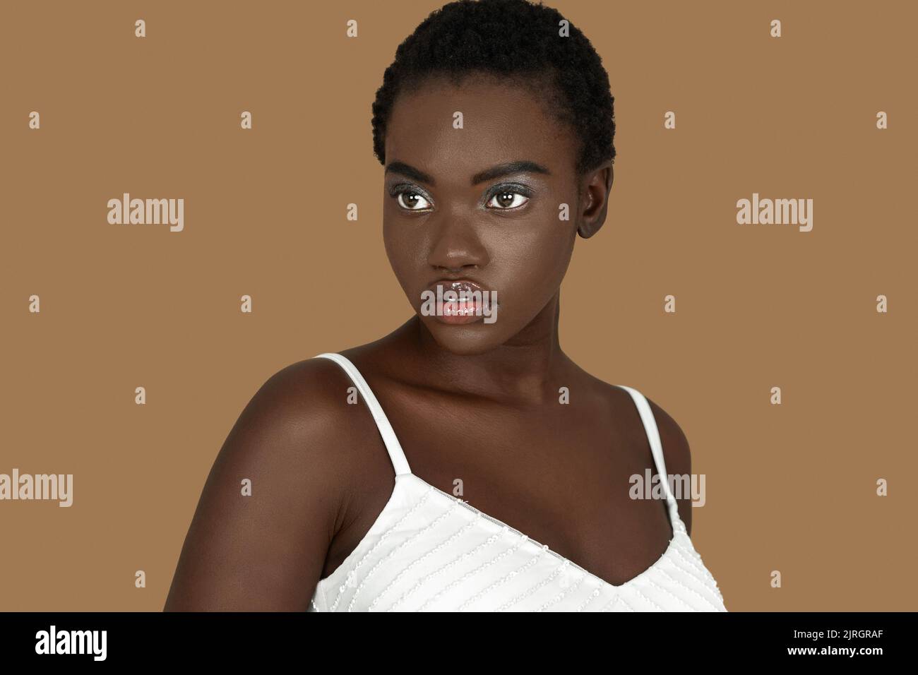 Portrait of a serene young black woman with short Afro hair, light ...