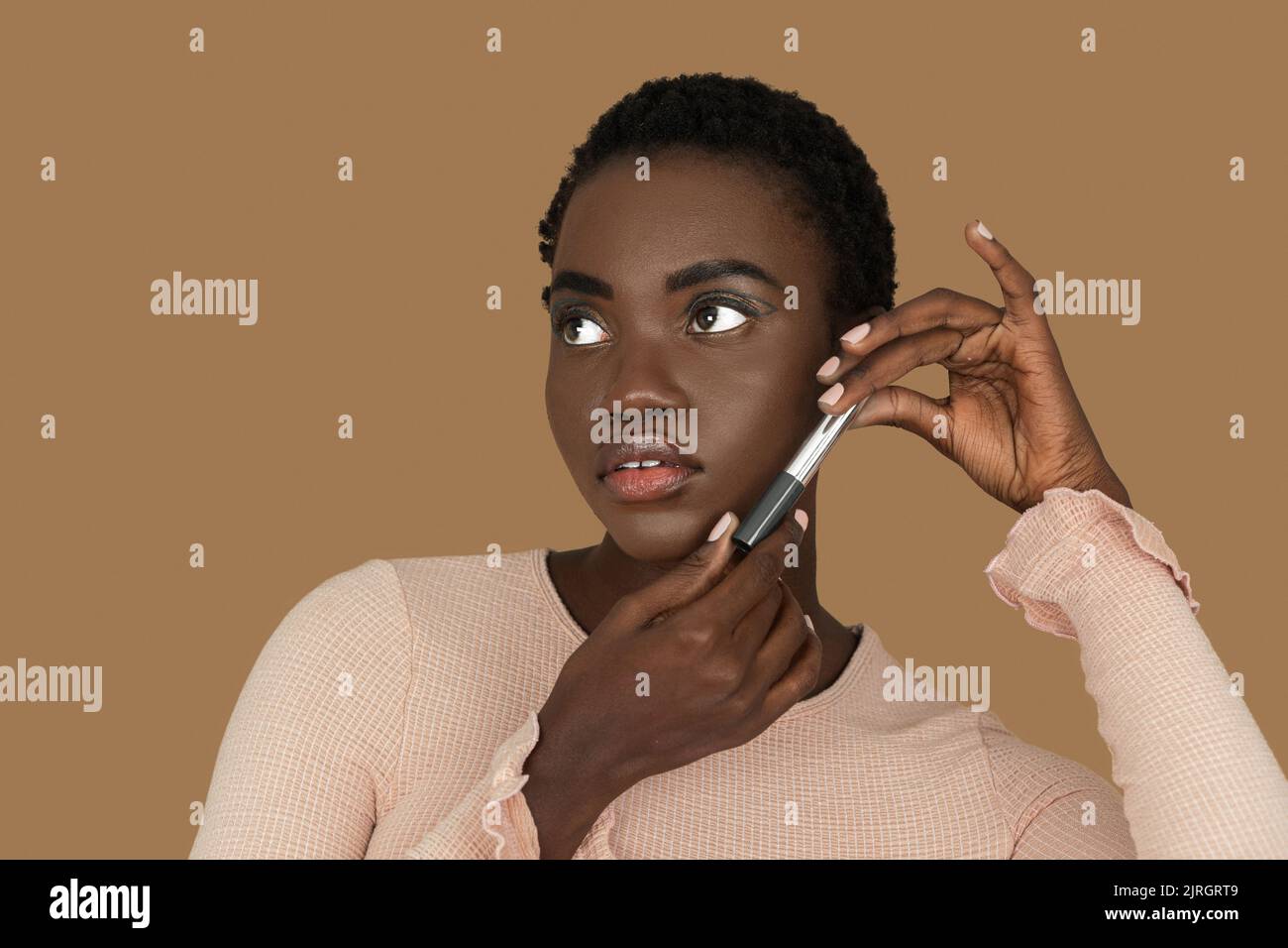 Portrait of a beautiful young black woman with short Afro hair, light ...