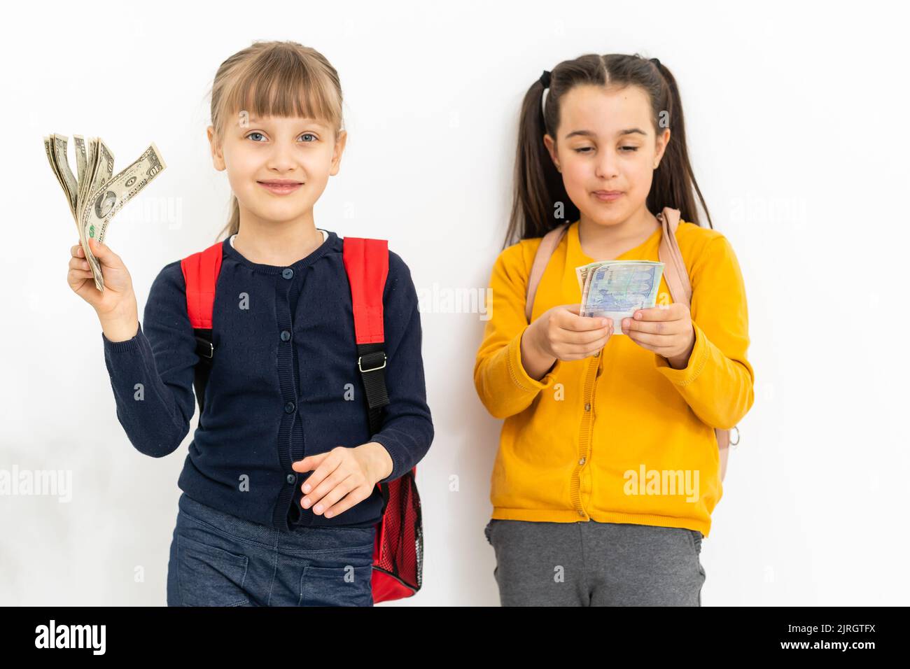 two little girls with money dollar. Isolated Stock Photo - Alamy