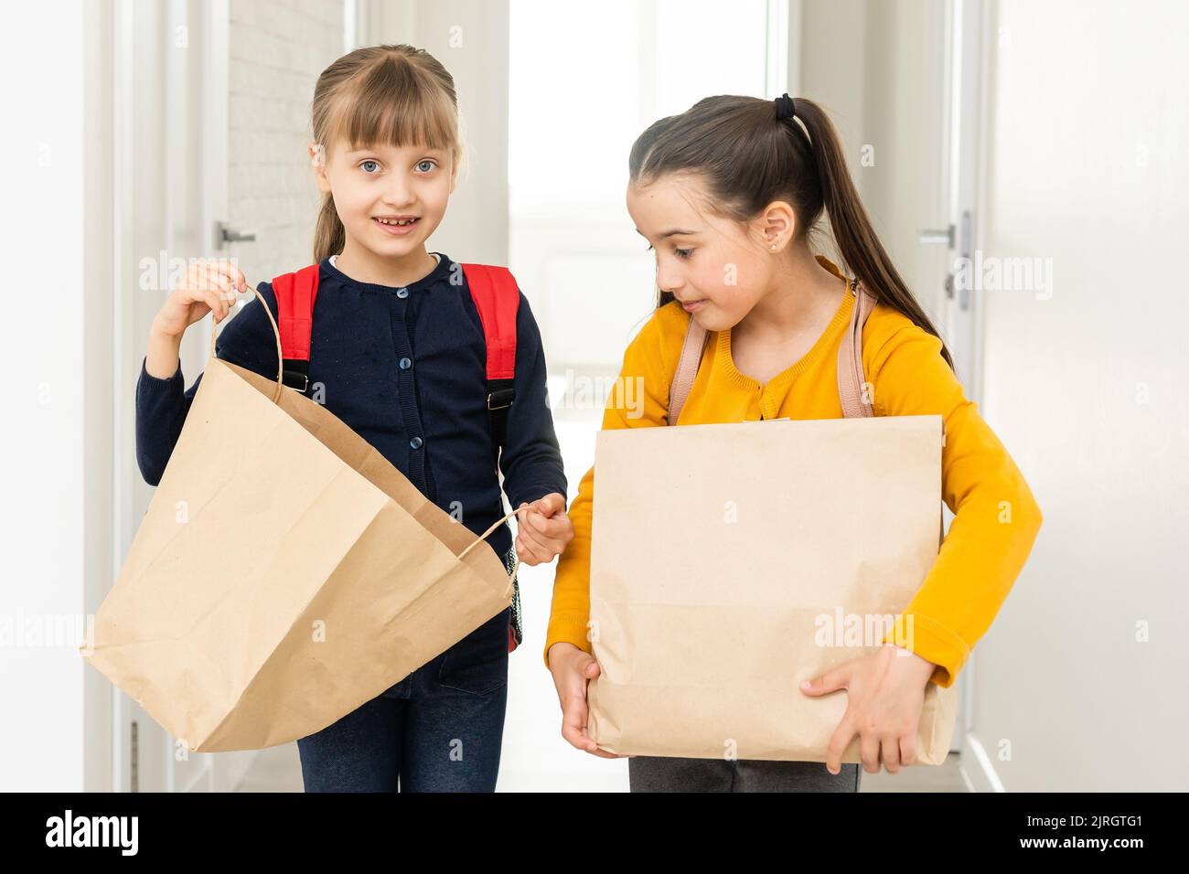 two schoolgirls with delivery packages Stock Photo - Alamy