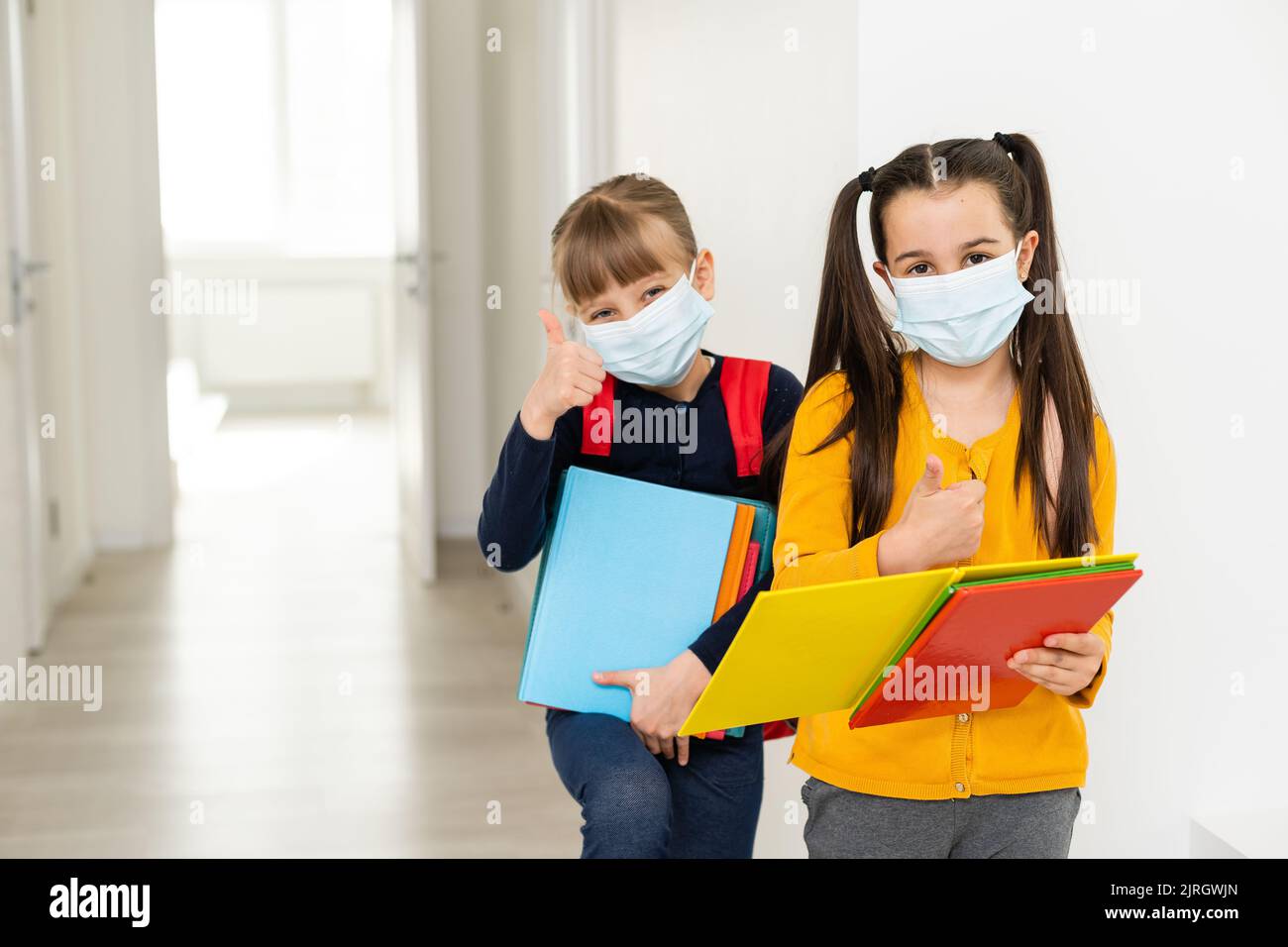 Close-up portrait of two nice attractive girls wearing safety mask ...