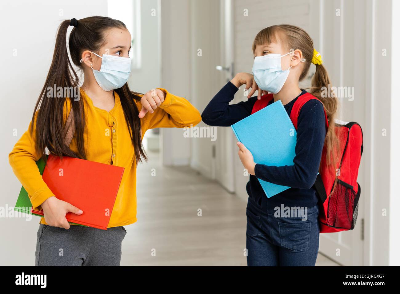 Close-up portrait of two nice attractive girls wearing safety mask ...