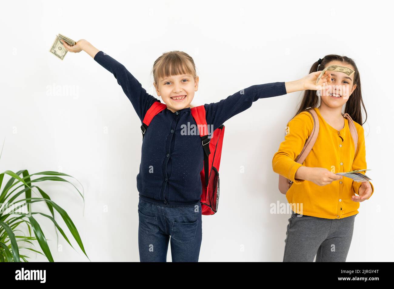 two little girls with money dollar and euro Stock Photo - Alamy
