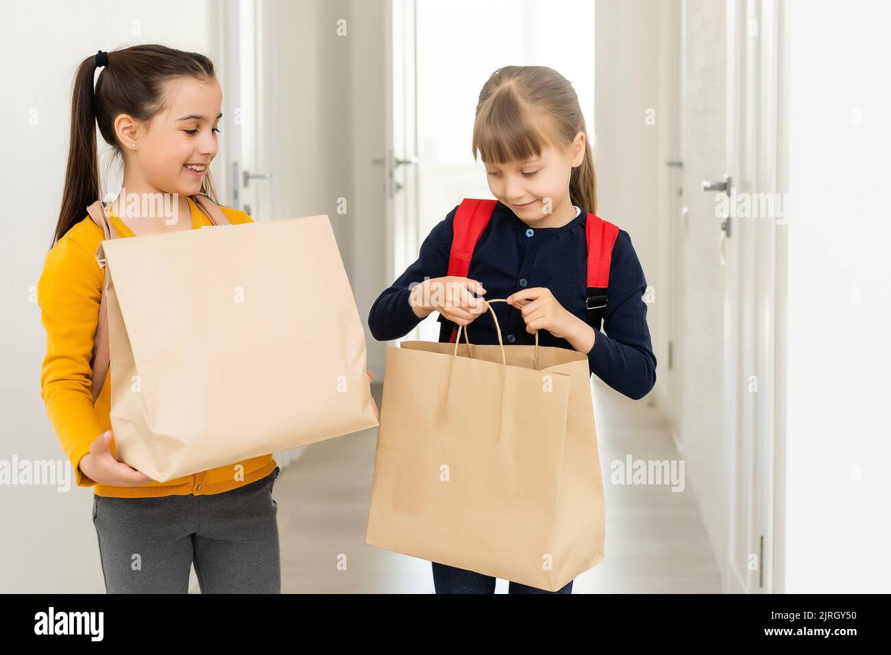 two schoolgirls with delivery packages Stock Photo - Alamy