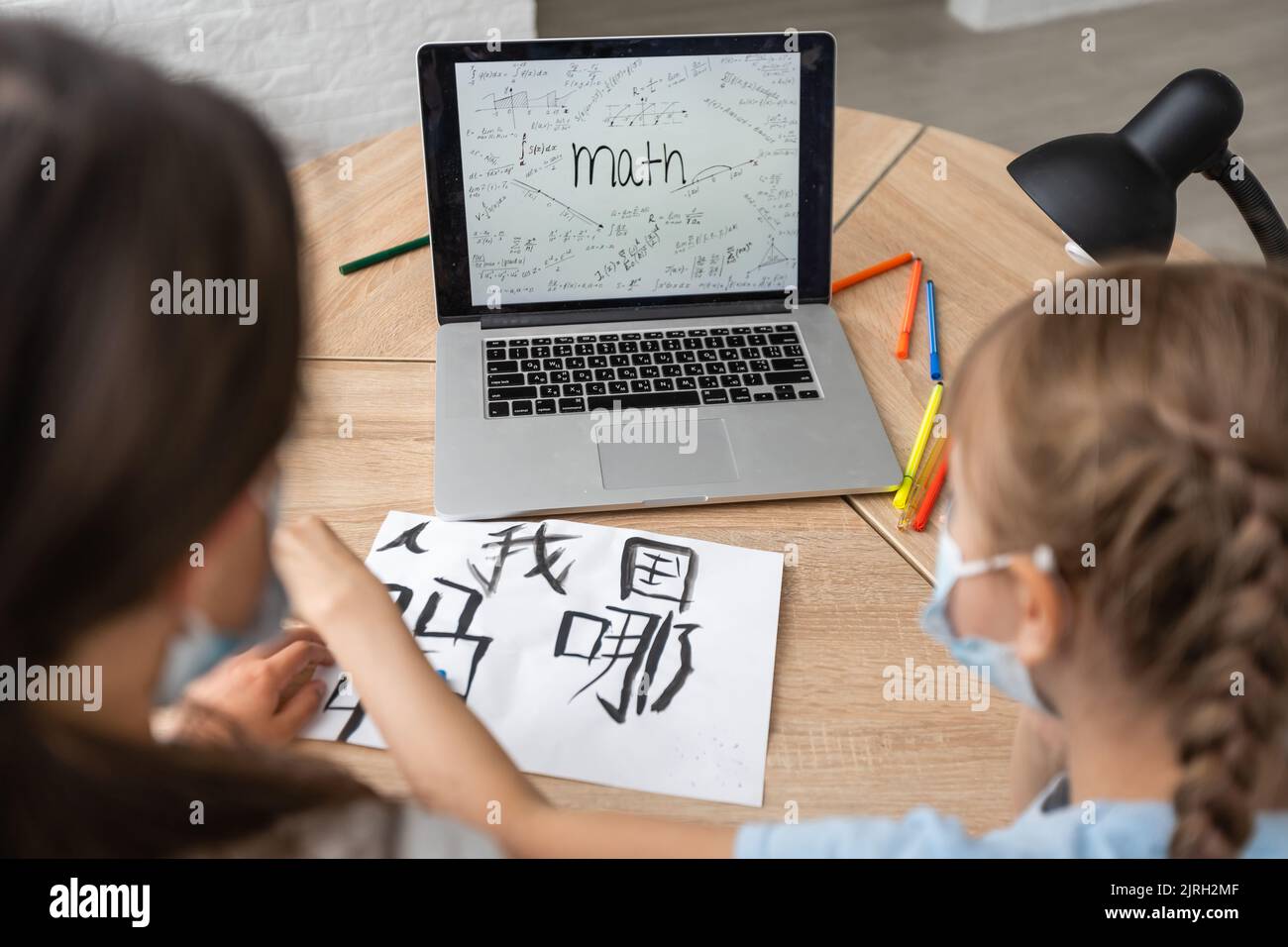 Distance learning online education. A school girls study at home and do ...