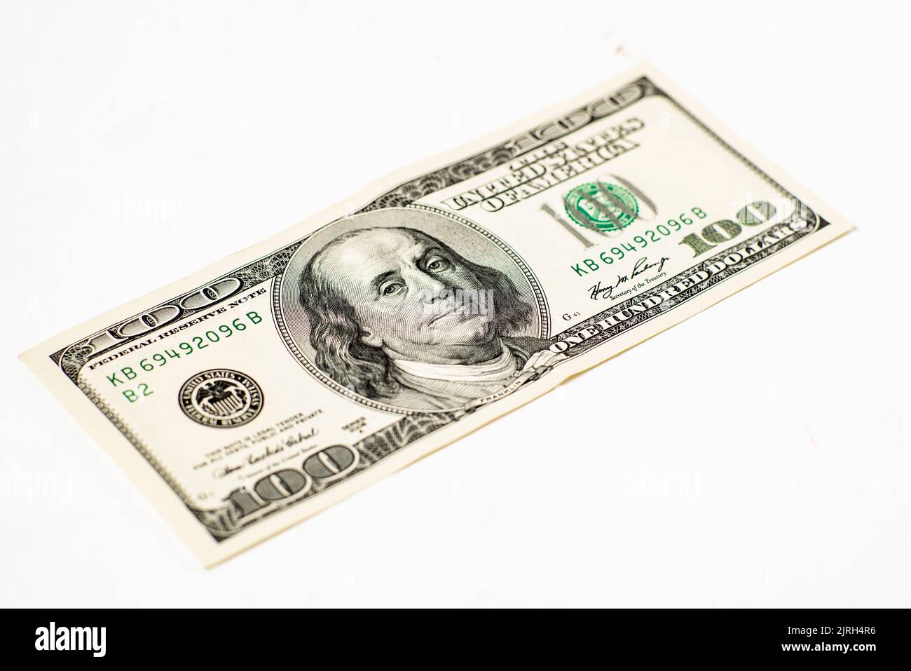 100 dollar bill lies on a white background Stock Photo - Alamy