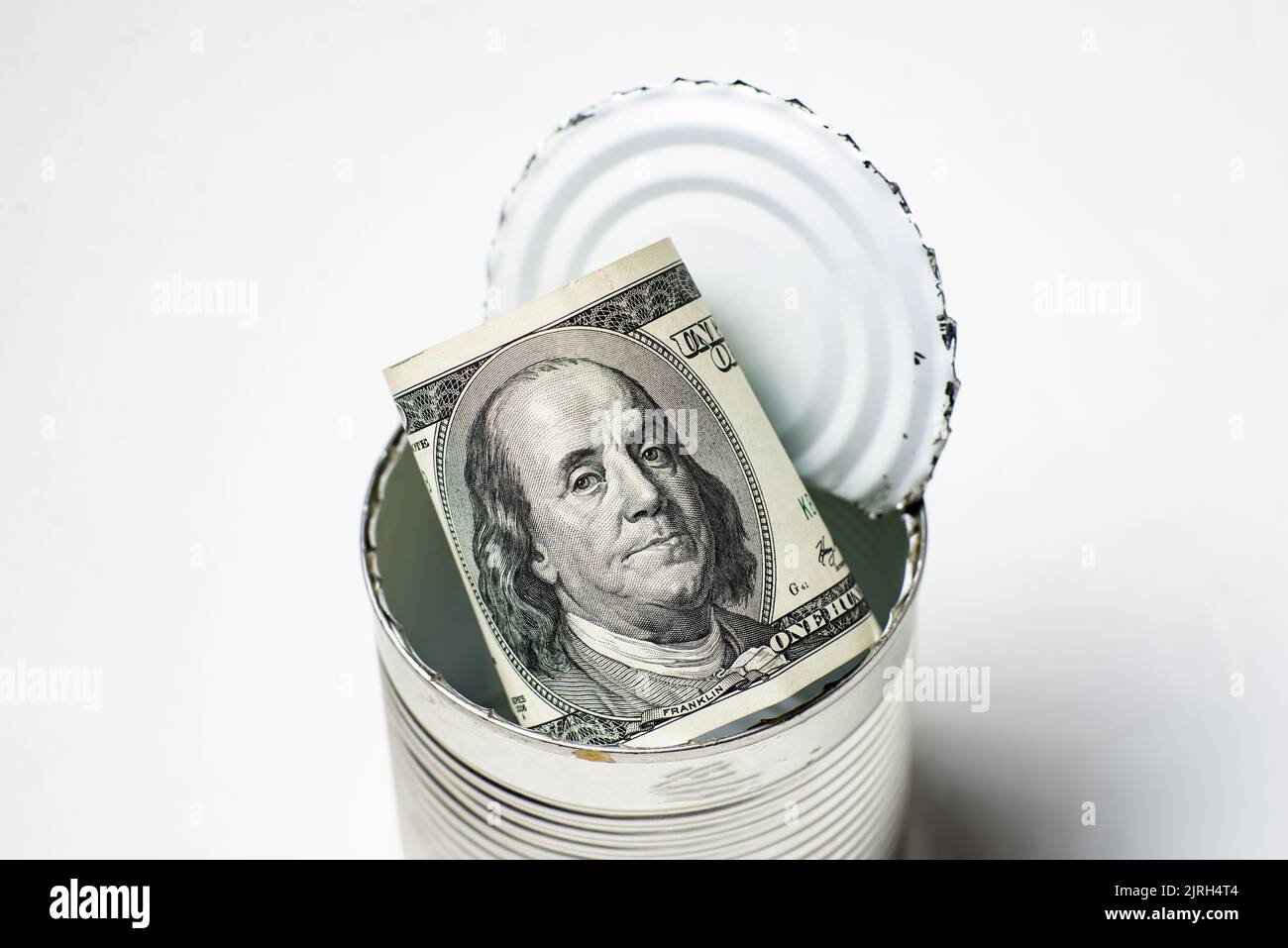 Dollars in an open tin can. Safeguarding cash, stash concept. Time to ...