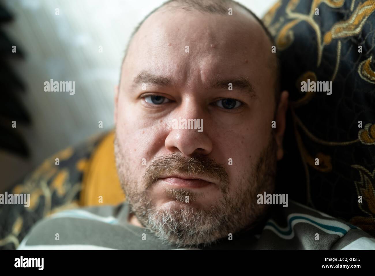 Ordinary middle aged man. The unshaven face of a man in his forties ...