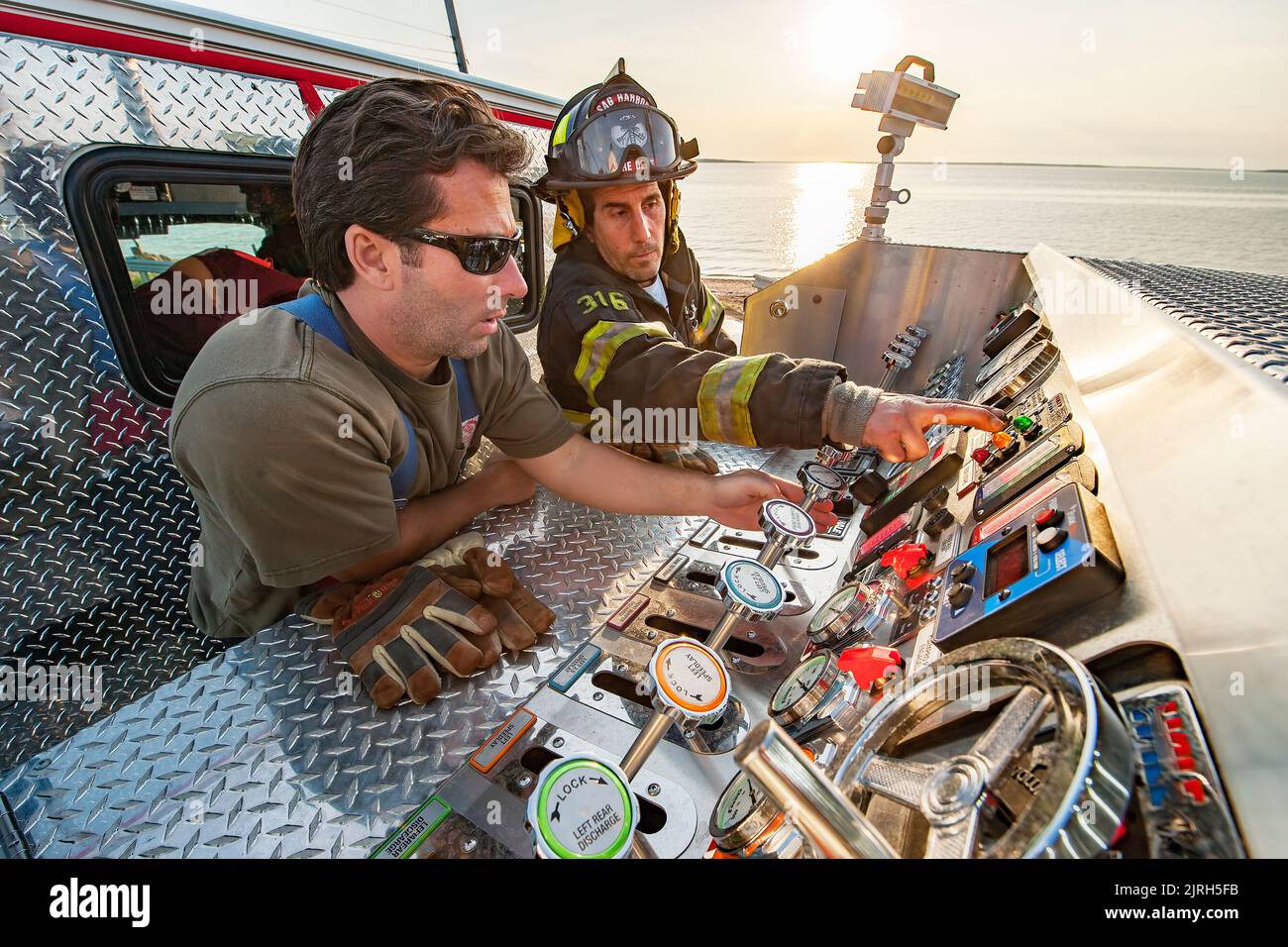 Sag Harbor firefighter Sal Lantiere instructs another firefighter on ...